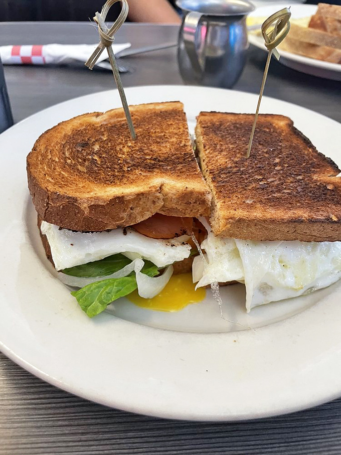 The breakfast sandwich in its natural glory—where the runny yolk creates nature's most perfect sauce between two pieces of perfectly toasted bread.