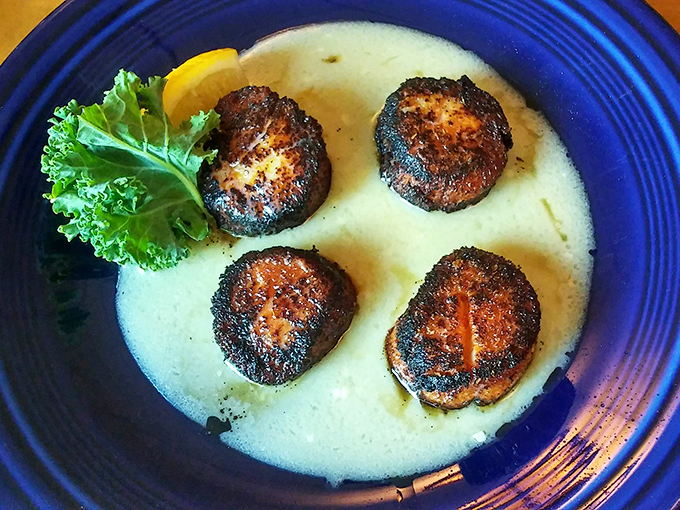 Seared scallops swimming in butter sauce &ndash; each one a perfect golden-brown medallion of oceanic delight in the heart of the northwoods.
