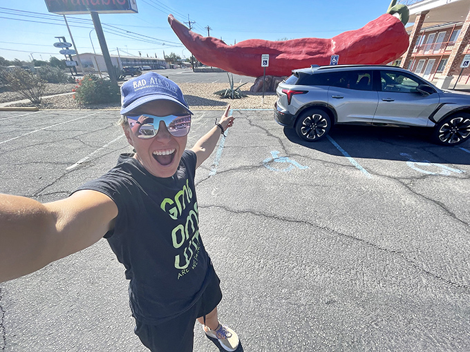 Pure joy radiates from this chile enthusiast's selfie – capturing that moment when you finally meet a roadside attraction you've always wanted to see.