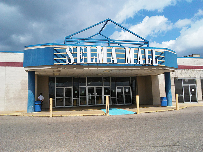 The Selma Mall sign stands as a cheerful blue beacon, promising retail therapy with a side of small-town charm.