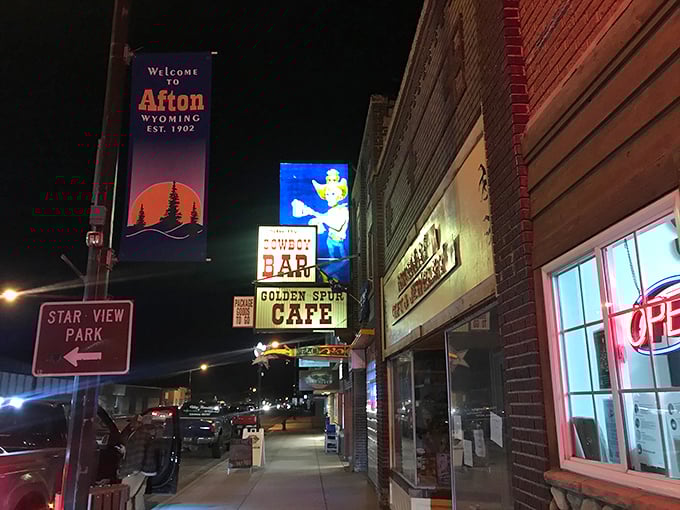 Shelly's Cowboy Bar glows with neon warmth after sunset, beckoning locals and travelers to share stories over affordable drinks.