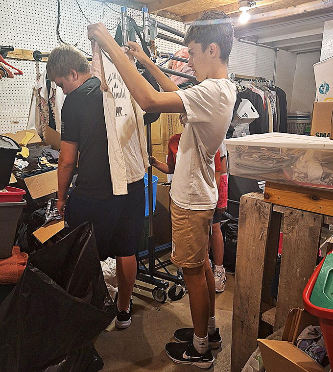 The thrill of discovery! Young shoppers learn the art of thrift store treasure hunting, carefully examining each potential wardrobe addition.