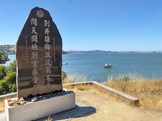 Ancient characters etched in stone stand sentinel over the bay, a cultural bridge connecting past journeys with today's spectacular views.