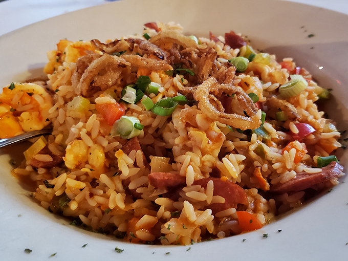 A colorful jambalaya that's like a party in a bowl. Rice, seafood, and vegetables dancing together in perfect harmony with a crispy onion crown