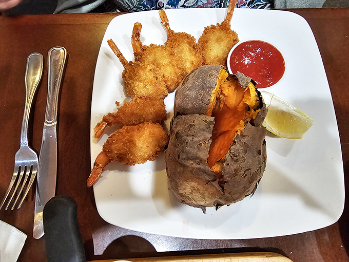 Golden-fried shrimp surrounding a baked potato bursting with orange flesh&mdash;a plate that makes you want to high-five the chef.