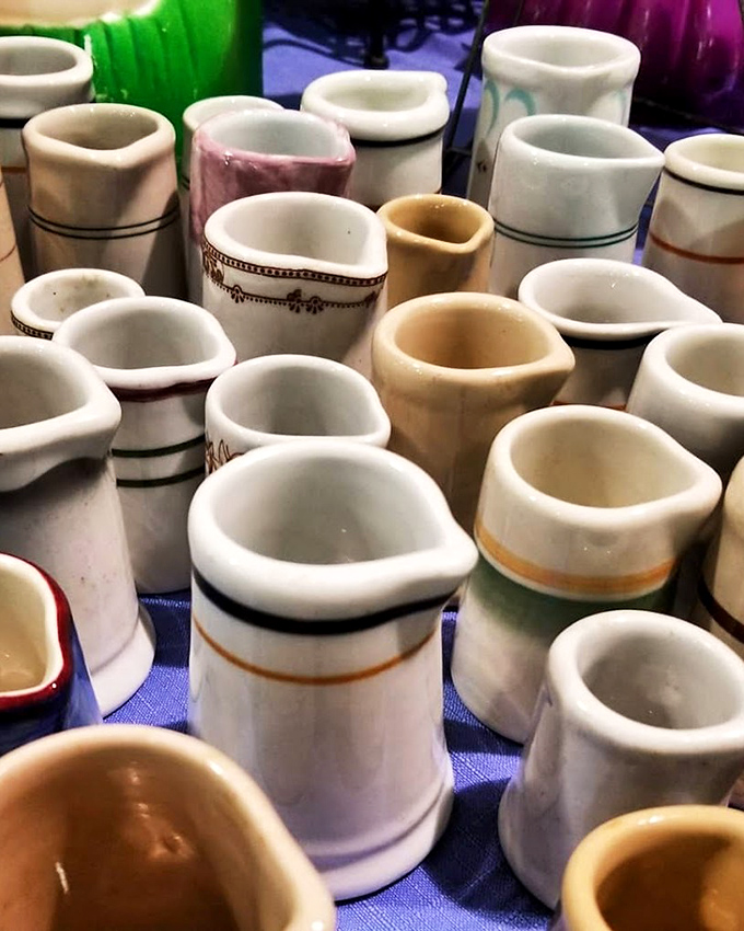 A congregation of creamers awaits new homes. Each one wondering if they'll pour coffee for hipsters or hold wildflowers on a farmhouse windowsill.