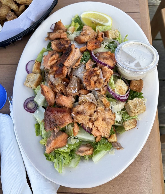 A salad that doesn't feel like punishment. Generous salmon chunks transform ordinary greens into something worth celebrating.