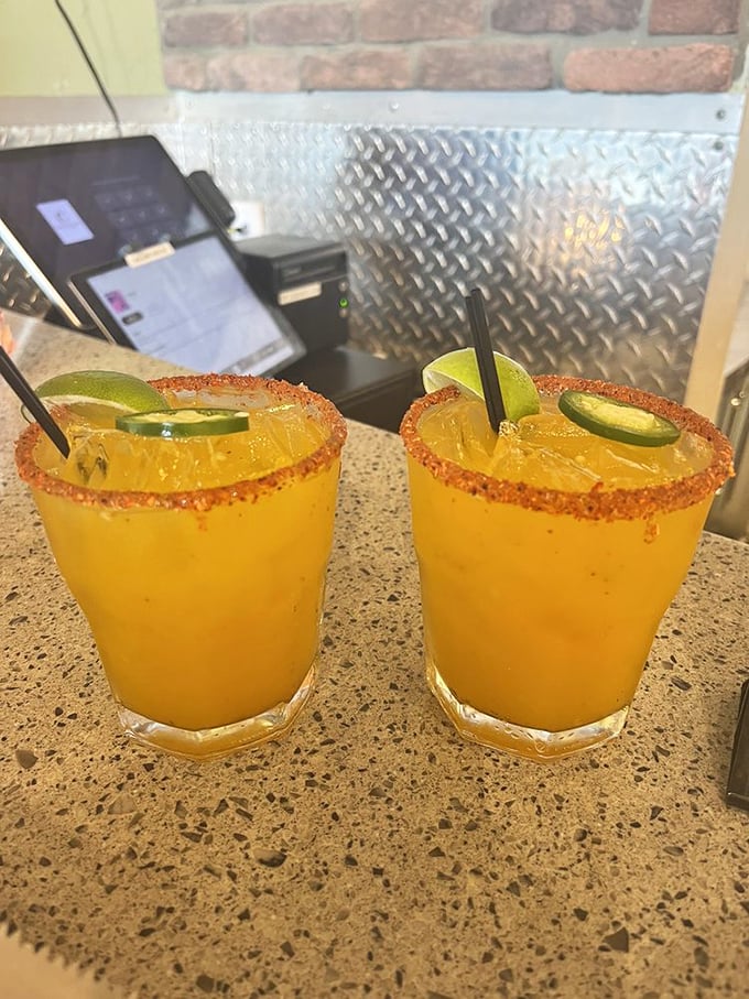 Spicy mango margaritas rimmed with chili&mdash;where tropical sweetness meets heat in a glass, like Florida sunshine with a rebellious streak.