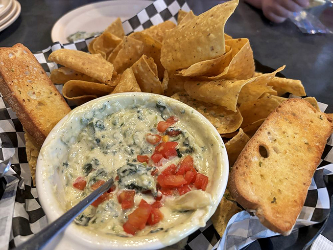 Spinach dip with chips and toasted bread&mdash;because sometimes you need vegetables, even if they're swimming in cheese.