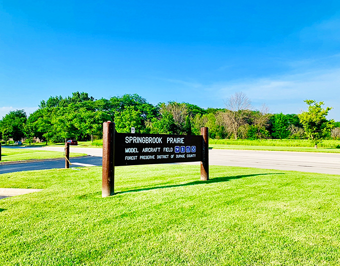 Springbrook Prairie's entrance sign promises wilderness adventures just minutes from drive-thrus and shopping centers.