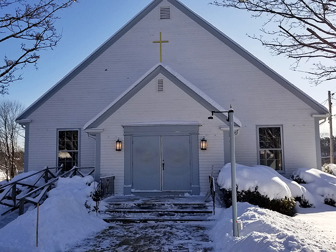 St. Jude's Church stands peaceful in winter's embrace, a quiet sanctuary amid the shopping district's bustle. 