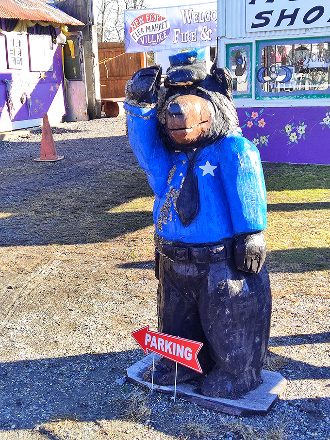 A blue-uniformed bear stands eternal watch over the parking area. When your directional signage doubles as folk art, you know you're somewhere special.