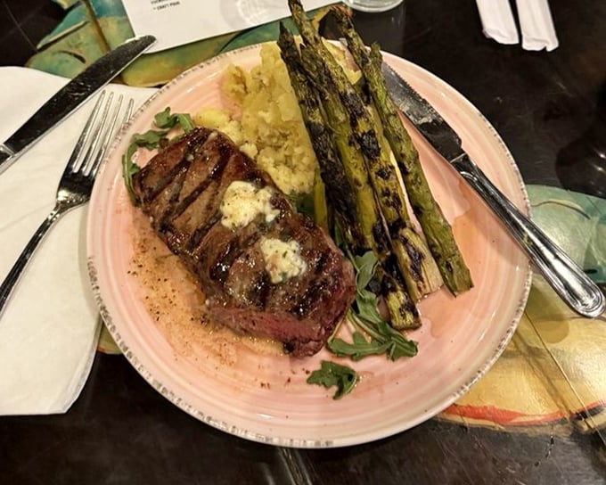 A perfectly seared steak for landlubbers who wandered into seafood territory. The char marks are like a delicious road map to flavor town.