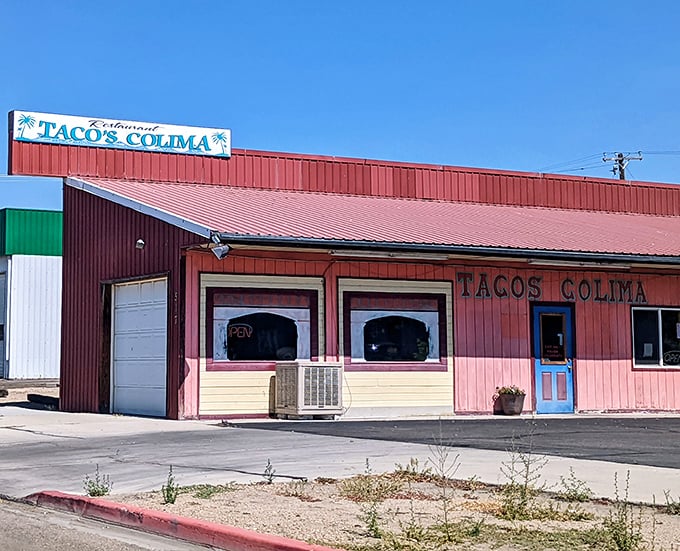 Tacos Colima's vibrant pink exterior promises authentic Mexican flavors that put chain restaurants to shame.