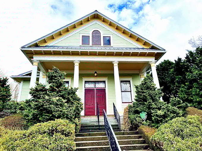 The Tim Noah Thumbnail Theater's mint-green facade and crimson door promise intimate performances where every seat feels front-row special.