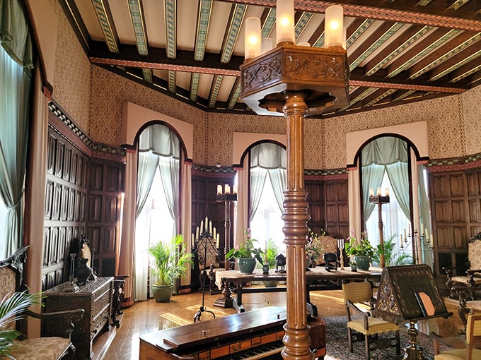 Ornate ceilings, rich wood paneling, and elegant furnishings create a room where even Netflix-binging would feel sophisticated.