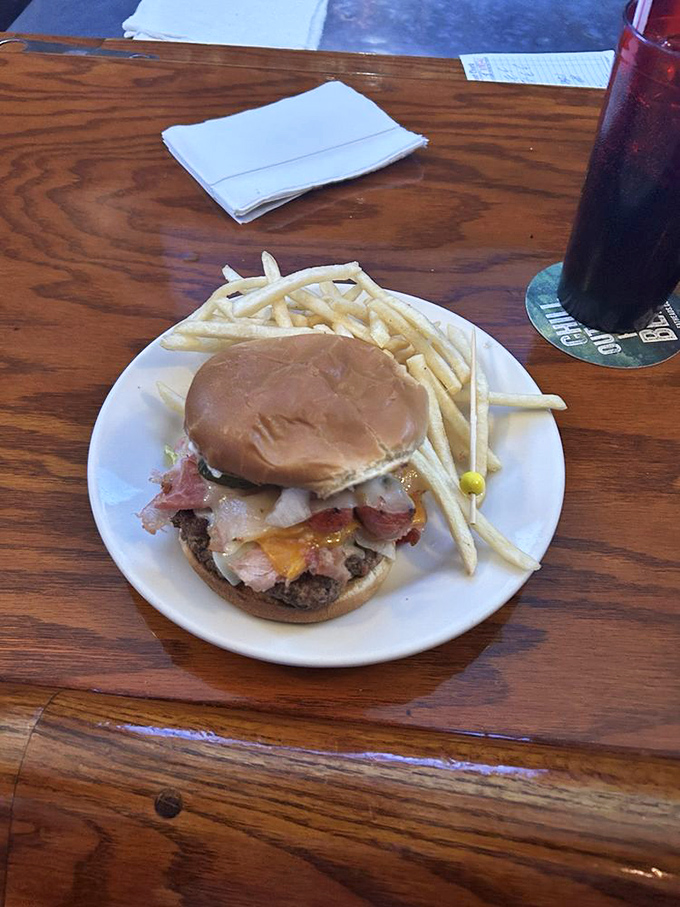 A burger that doesn't need Instagram filters—just honest ingredients stacked high with onion rings that shatter satisfyingly between your teeth.