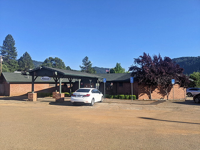 That mountain backdrop makes even a simple brick building look like it belongs on a postcard you'd send to make friends jealous.