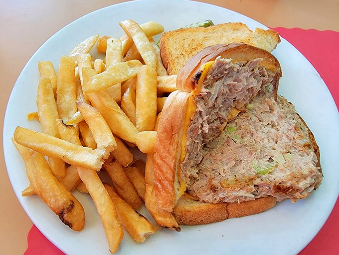 The tuna melt arrives with fries so perfectly golden they make you wonder why anyone bothers with truffle oil or fancy aioli.