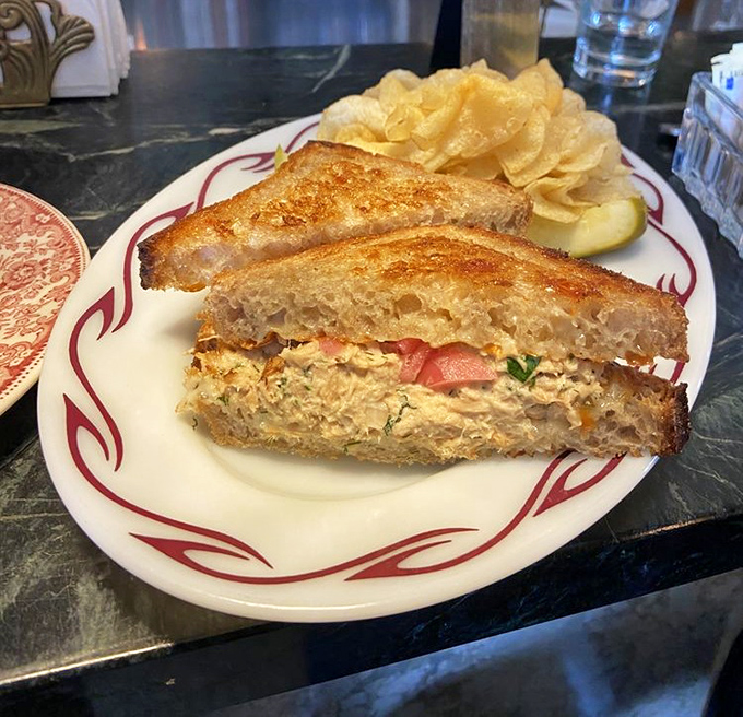 The humble tuna melt, elevated to art form. Served on vintage china because paper plates would feel like putting Pavarotti in a karaoke bar.