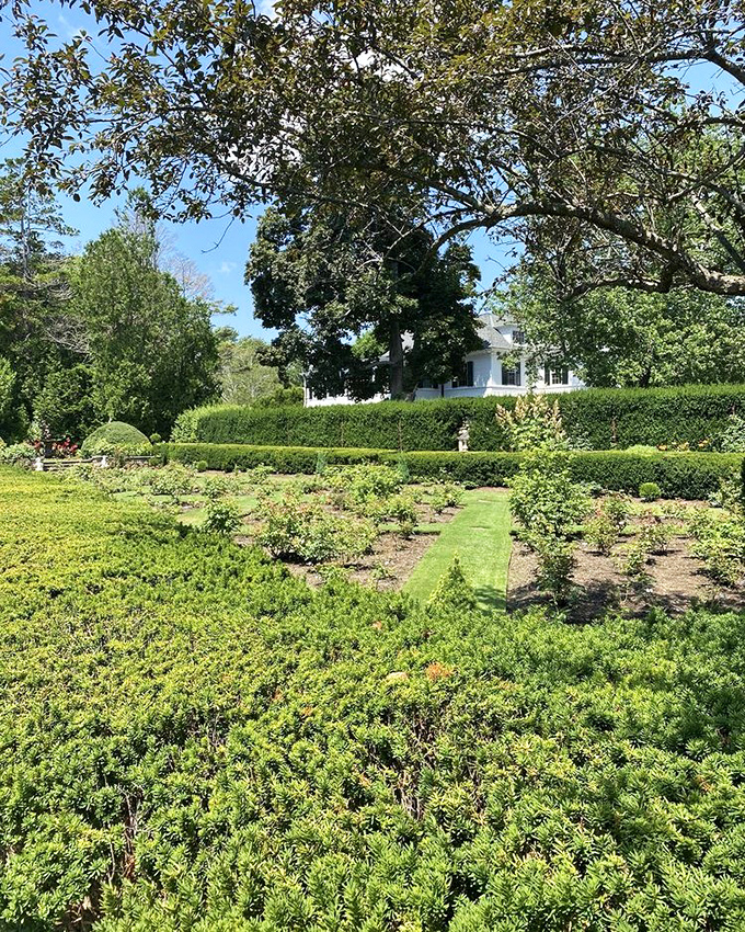 Formal gardens spread out like a green quilt, each section stitched with precision and care.