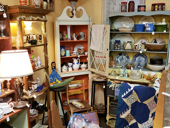 A quilt waits patiently among teacups and figurines. Someone's grandmother made both the quilt and many of the memories on these shelves.