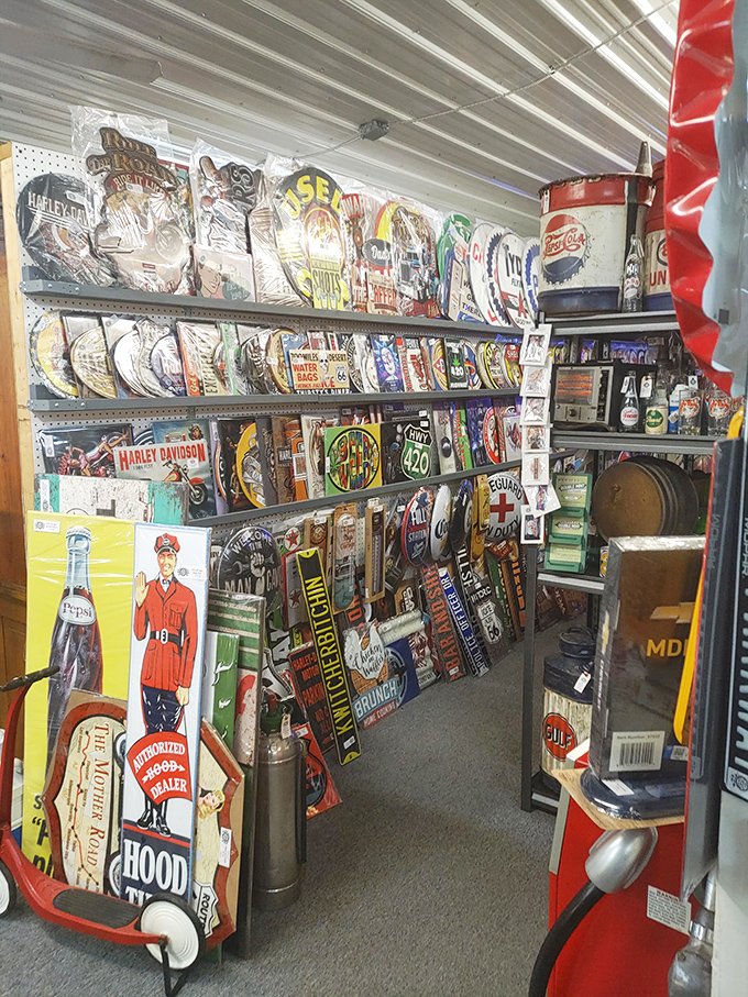 A metal sign collector's dream corridor—where Route 66, Harley Davidson, and forgotten gas stations live forever in perfectly rusted glory.