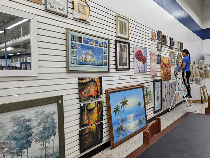 The art wall &ndash; where forgotten paintings find new admirers. That palm tree scene is just screaming "Florida living room makeover."