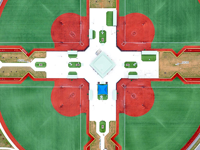 Winged Deer Park's athletic complex creates a geometric masterpiece from above, where the serious business of play unfolds in vibrant color.