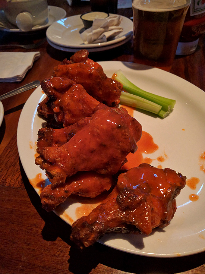 Buffalo wings glistening with sauce &ndash; the kind that requires extra napkins and zero regrets.