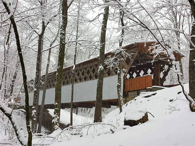 Winter transforms the bridge into something from a holiday card&mdash;snow-dusted timber creating a scene Currier and Ives would have rushed to paint.