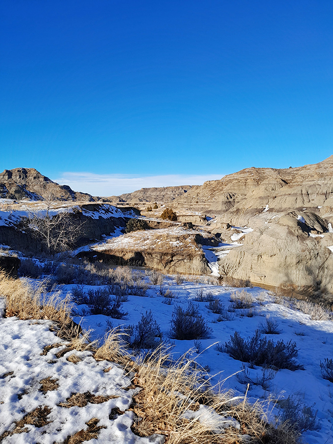 Winter transforms Makoshika into a hushed wonderland where snow highlights every contour of this ancient landscape.