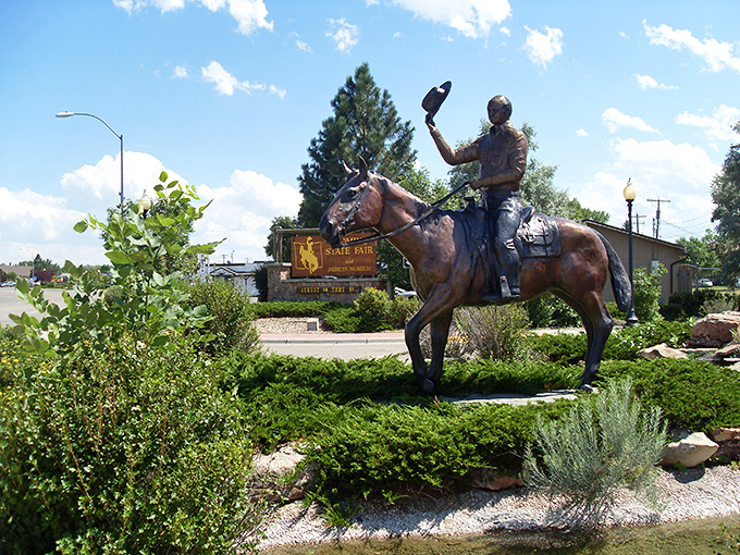 A bronze cowboy tips his hat to visitors at the Wyoming State Fair entrance, where authentic Western heritage isn't manufactured for tourists.