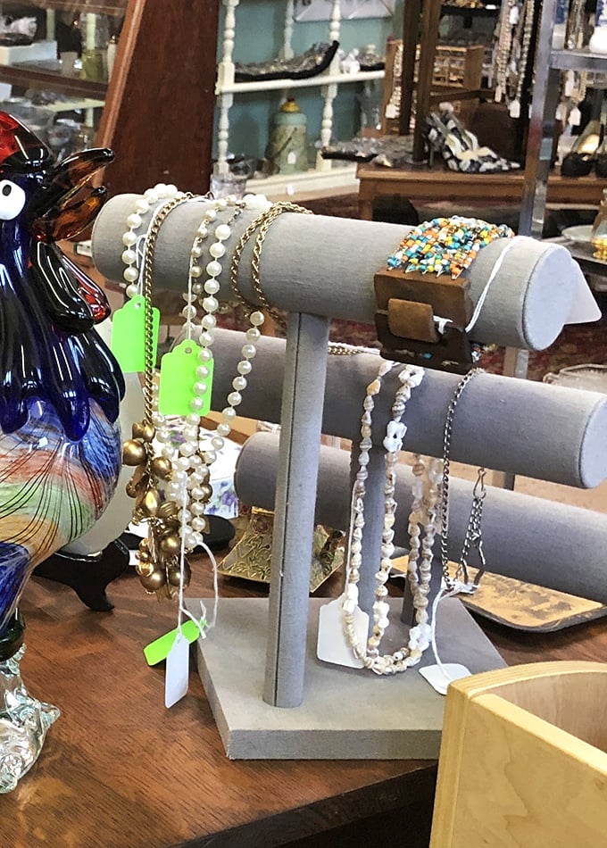 Pearls, chains, and vintage jewelry displayed on gray stands&mdash;because someone's forgotten treasure is about to become your signature accessory. 