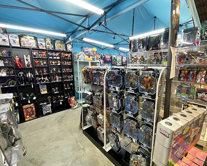 Action figure nirvana under blue tent lights&mdash;where collectors speak in hushed tones about rare editions and childhood heroes.