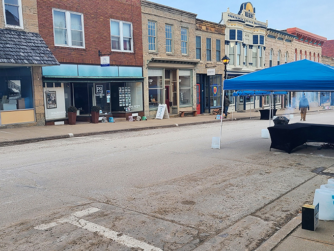 Market day transforms the streets into a community gathering space, where locals and visitors mingle among colorful canopies and storefronts.
