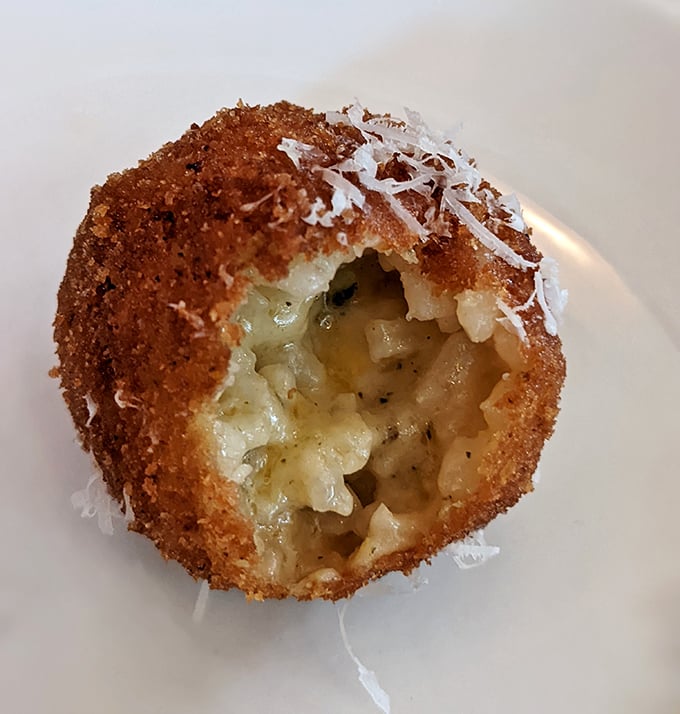 One bite of this golden arancini reveals its molten secret &ndash; creamy risotto and cheese hiding inside a perfectly crisp exterior. Rice has never been so exciting.