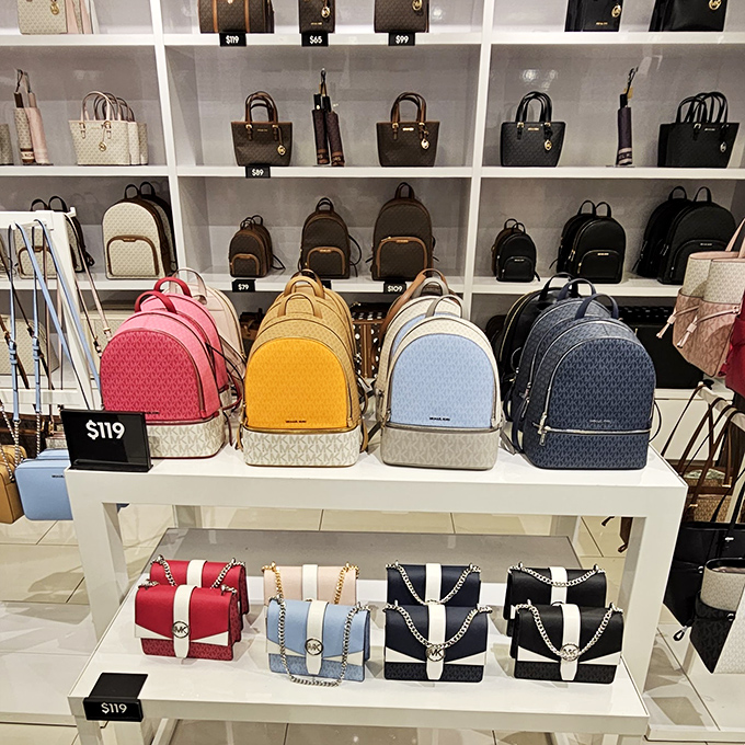 Designer backpacks in candy colors that whisper "luxury" while shouting "sale!" Fashion math at its finest.