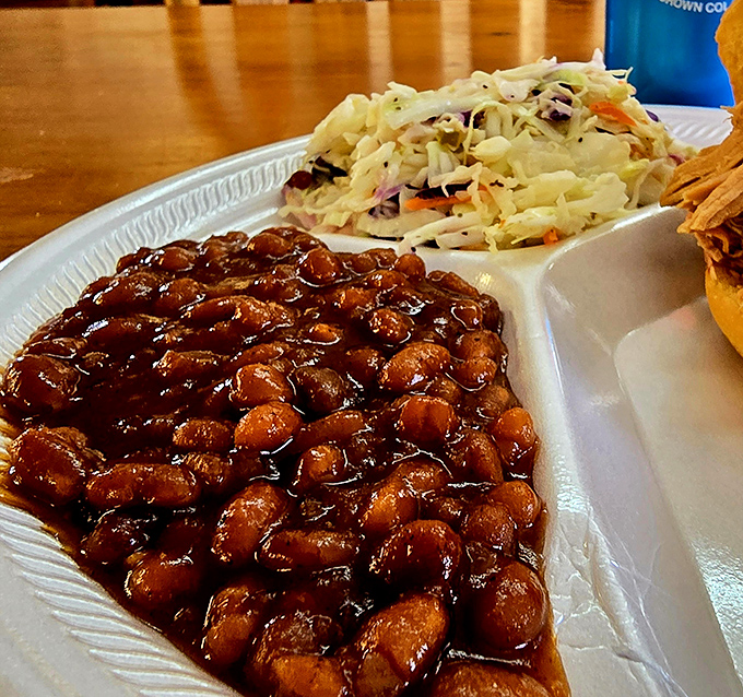 Baked beans so rich and saucy they deserve their own ZIP code, nestled beside coleslaw that provides the perfect crisp counterpoint.
