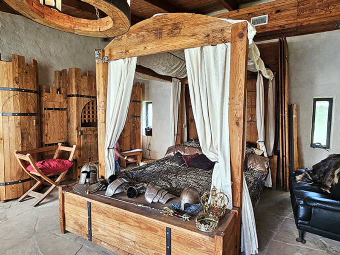 Four-poster beds with flowing curtains transform guest rooms into royal chambers fit for medieval nobility.