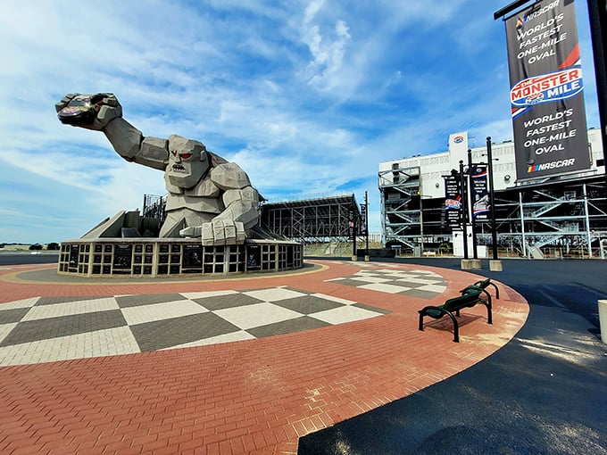 The checkered plaza surrounding Miles mirrors the finish line pattern, a subtle reminder that you're standing in racing royalty's front yard.