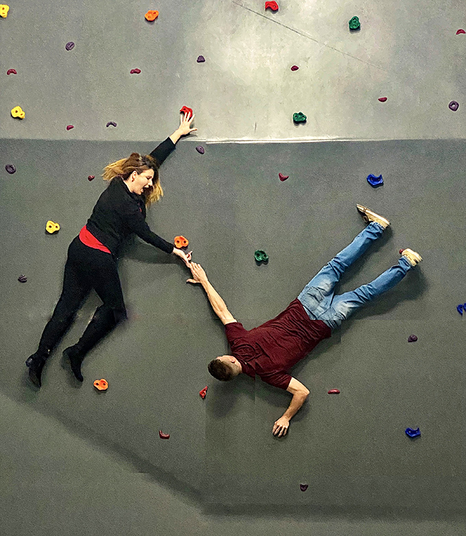 "Honey, I think we're doing rock climbing wrong." This clever perspective illusion transforms a flat floor into a gravity-defying climbing wall adventure.