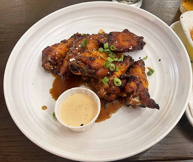 Wings that have clearly been introduced to fire and spice in the most intimate way possible. That dipping sauce is just the beginning of a beautiful friendship.