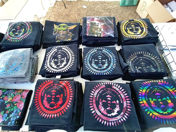 Pop culture meets traditional designs in this t-shirt display. Baby Yoda shares space with sacred symbols—the perfect souvenir fusion.