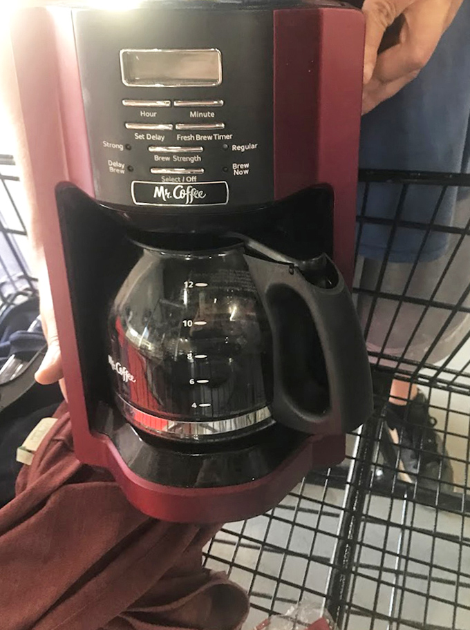 A burgundy Mr. Coffee machine that's seen a few morning rushes stands ready for its second act in someone else's kitchen drama.