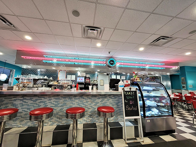 The counter isn't just seating&mdash;it's front-row tickets to the culinary show, complete with neon lighting worthy of a 1950s musical.