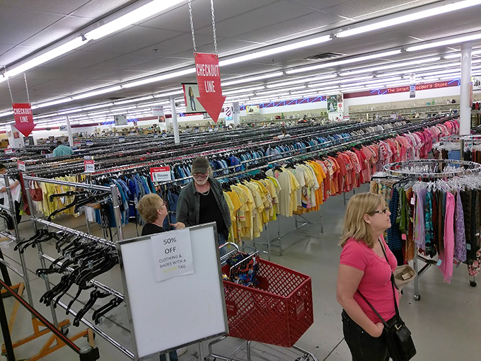 The clothing section: color-coded for efficiency, where savvy shoppers hunt designer labels hiding among everyday treasures.
