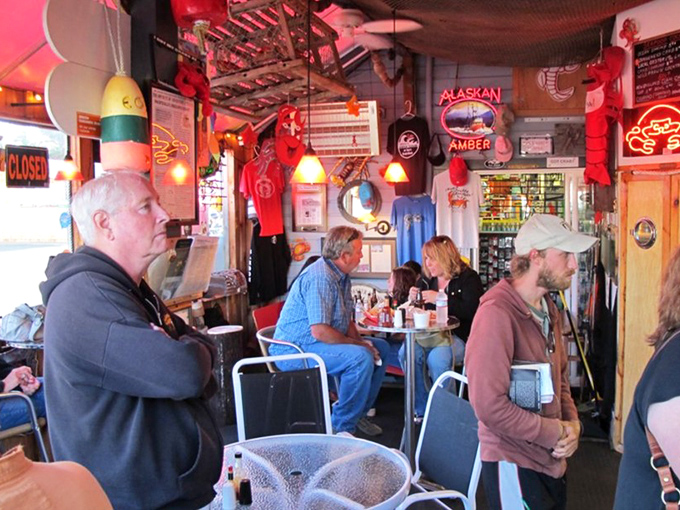 Happy diners dig into their seafood treasures surrounded by maritime memorabilia and coastal dining bliss.