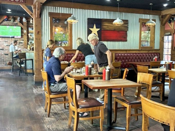 The Texas flag watches over diners like a proud parent. Those leather booths have witnessed countless barbecue epiphanies and sauce-stained smiles.