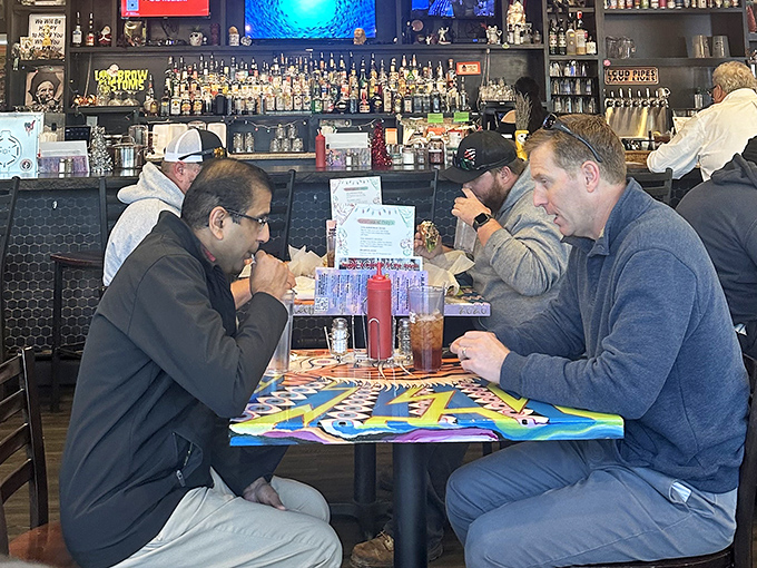 Strangers become friends over burgers at Pinky's, where the tables may be simple but the conversations are anything but.